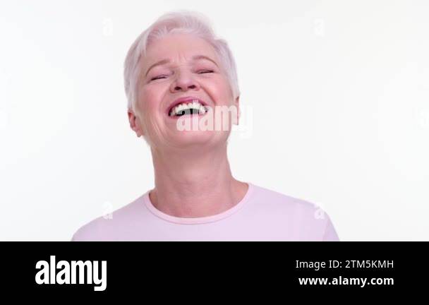 Joyful Senior adult woman bursts into laughter, eyes crinkling with ...