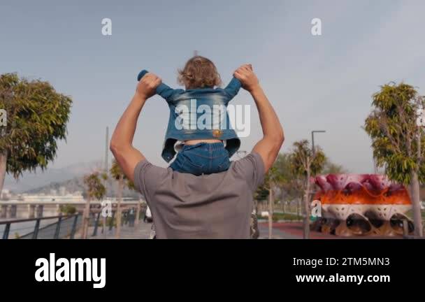 The son sits on the shoulders of his father, plays a pilot, flies as a ...