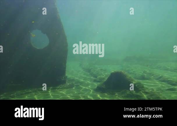Underwater seascape scene with giant rocks and and reef with sunlight ...