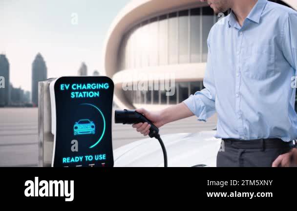 Hand pull EV charger from smart electric charging station display ...