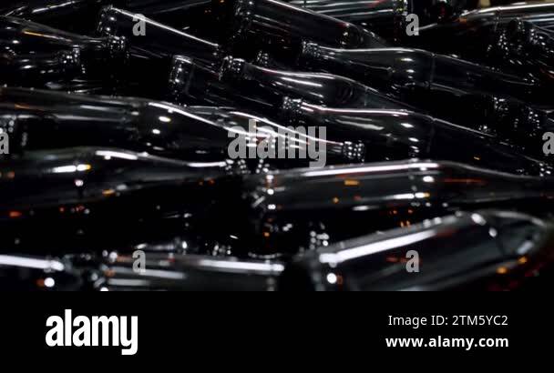 Heap of bottles stacked at glass recycling factory. From above pile of ...