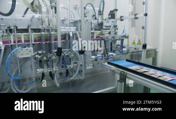 Packaged goods at automated production line. Packaging of drug. Medical ...