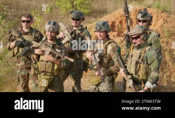 Army Men wearing Tactical Uniform and holding Machine gun standing on ...