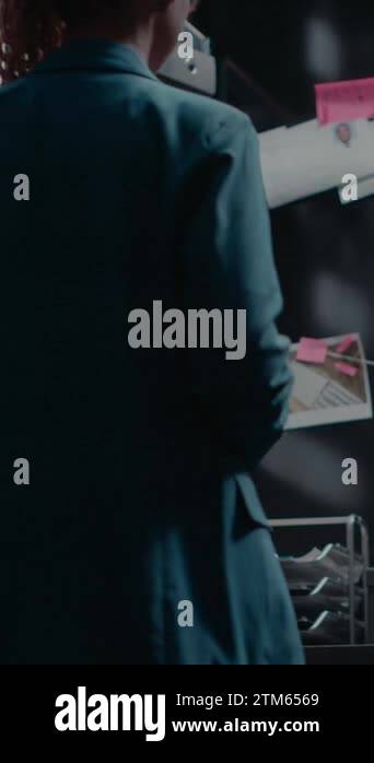 Vertical video: Inspector conducting criminal investigation in archive ...