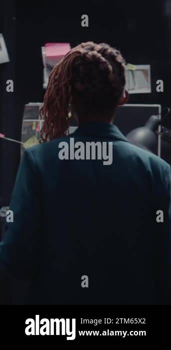 Vertical video: Law enforcement agent checking detective evidence map ...