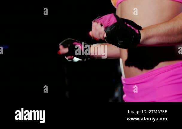 Warm up before a hard workout. Female hands in gloves do exercises to ...