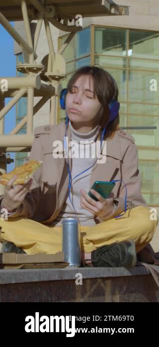 Slow motion 4k footage - teenage girl eating pizza outdoors. Youth ...