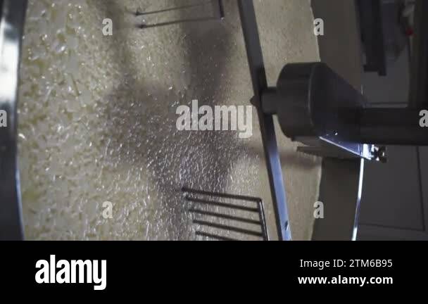 Curd and whey in tank automatic mixing at cheese factory. Curdled milk ...