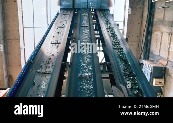Process of sorting glass garbage on a conveyor belt at waste sorting ...
