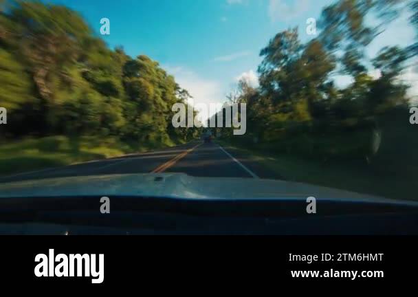 Road view through the car windshield. POV of the car moving on an ...