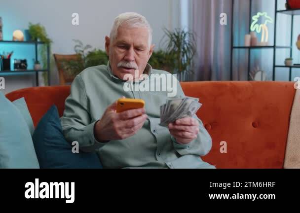 Planning family budget. Senior grandfather man counting money cash, use ...