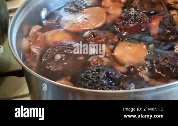 Preparation of dried fruit compote in a saucepan. Slow bubbling of ...