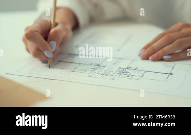 Closeup of professional young beautiful architect hand drawing ...