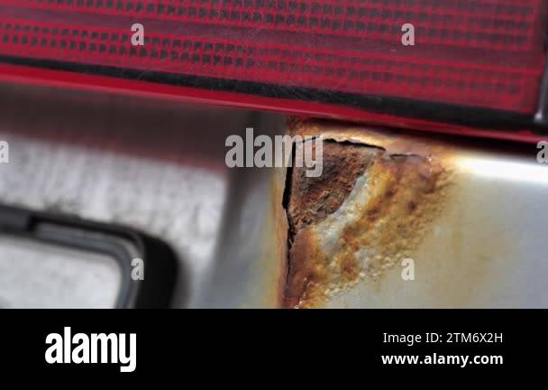 Heavily rusty car body. Rotten upholstery and peeling paint on top. The ...