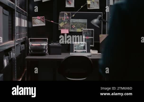 Private inspector examining clues and records, conducting criminal ...