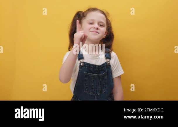 Portrait of little girl kid shakes finger and saying no, be careful ...