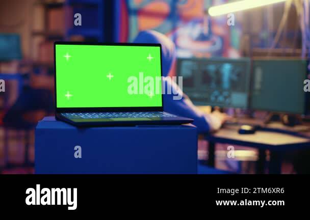 Green screen laptop used by hackers in underground hideout to write ...