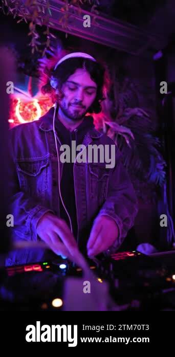 Vertical Video, Male DJ Creates Dynamic Atmosphere on Dance Floor with ...