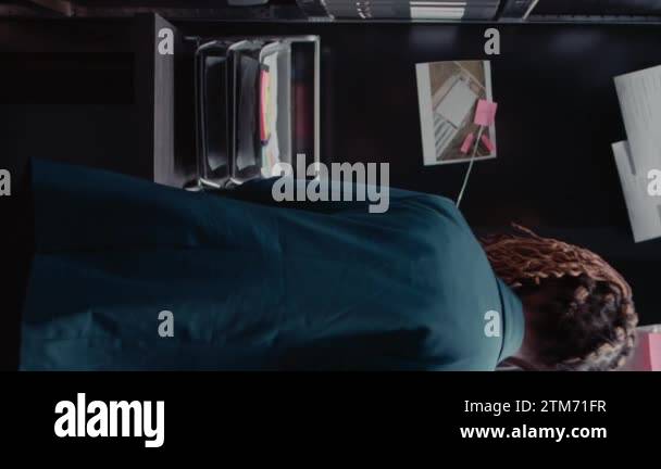 Vertical video: Professional officer reviewing surveillance photos on ...