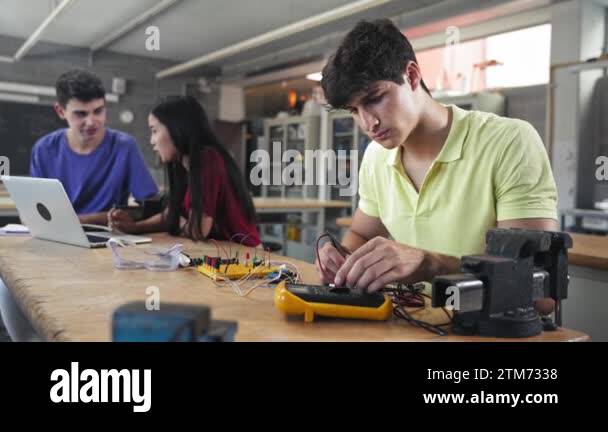 College Student building electronics circuit in the engineering ...