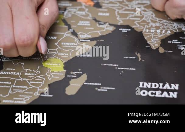 Woman hand erases visited country of Tanzania on the travel map ...