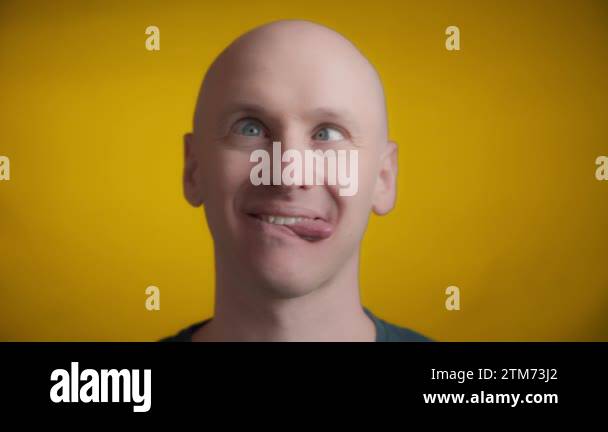 Man makes a goofy face with his tongue sticking out to the side and his ...