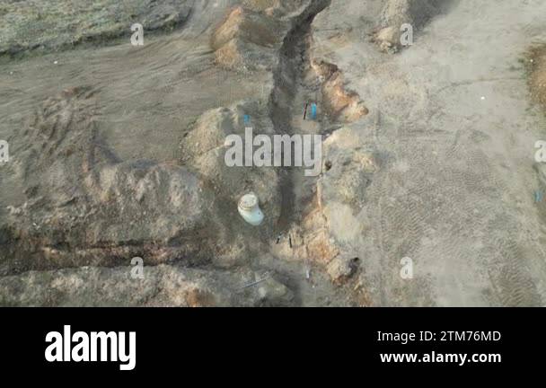 sewer excavations and piles of earth at the construction site ...