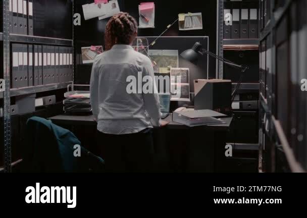 Law officer examining archived criminal records at police station ...