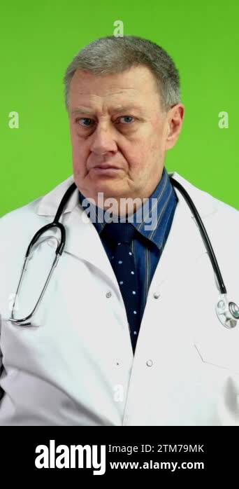 Senior doctor in white coat showing negative examination results ...