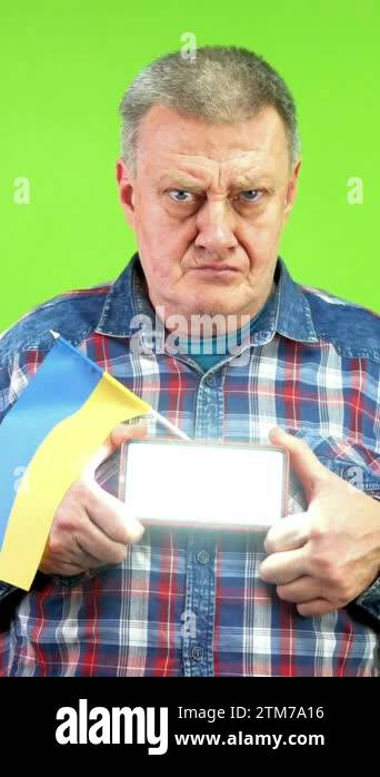 Mature man with ukrainian flag gives sos signal Morse code using ...