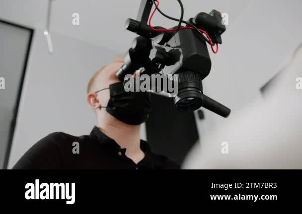 At the dental clinic a dentist examines a patient with toothache under ...