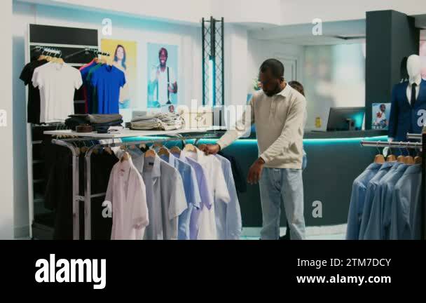 African american shopper taking clothes in fitting room to dress up ...