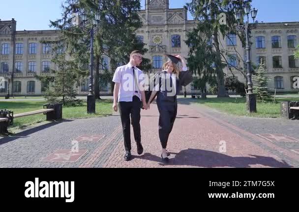 Happy Graduands Couple Walking by Cobblestone Alley at the University ...