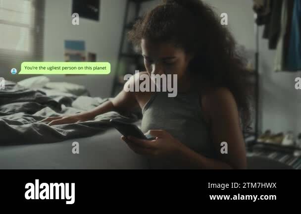 Frustrated black girl getting bullying messages on mobile phone and ...