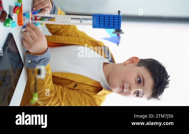 Robotics programming class. Children construct and code Robot. STEM ...