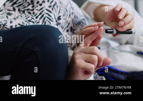 Vertical video: Elderly medic taking insulin level test using ...