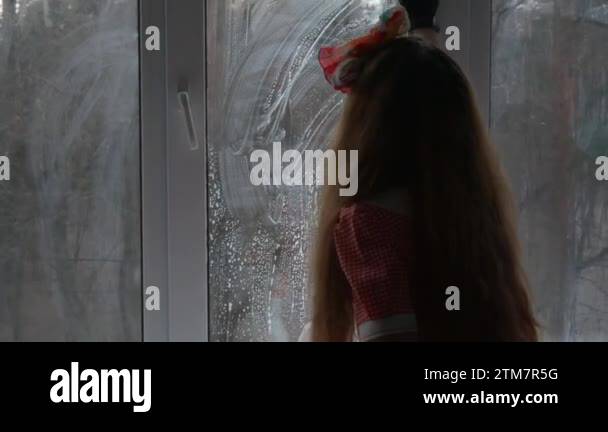 Dirty windows. A girl washes double-glazed windows at home. Window ...