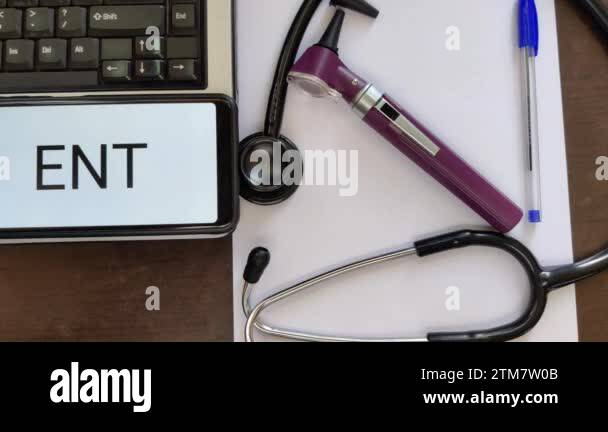Footage of an otoscope, stethoscope, white paper, laptop and ENT ...