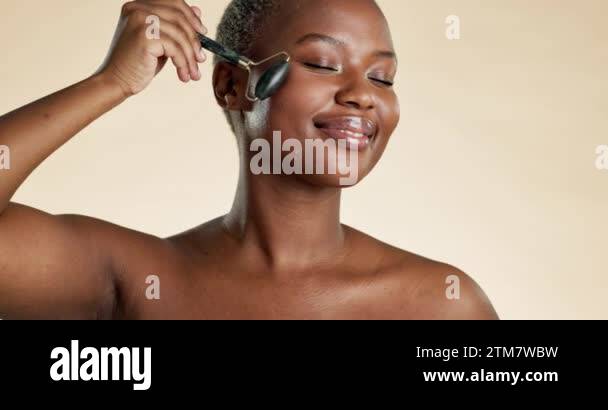 Skincare, black woman and face roller for dermatology, beauty and girl ...