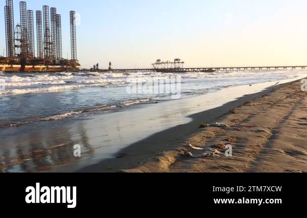 beach waves with oil platform in ocean. Caspian sea offshore oil rig ...