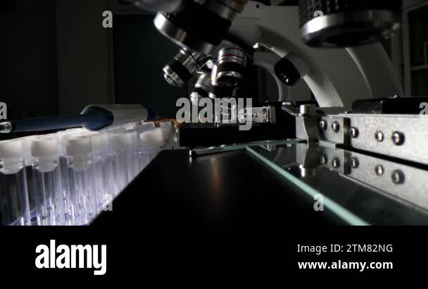 Closeup of observing magnification of lens of scientific microscope in ...