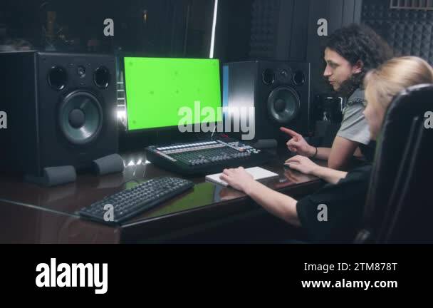 Computer screen showing DAW software interface. Female audio engineer ...