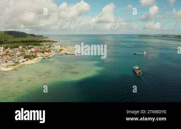 Passenger port with ferries and cargo ships on the island of Siargao ...