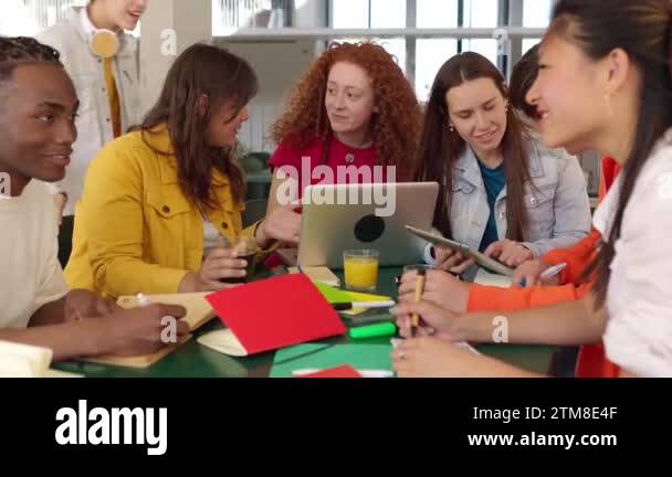 Diverse group of college students studying together at university ...