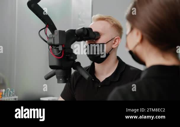 At the dental clinic a dentist examines a patient with toothache under ...