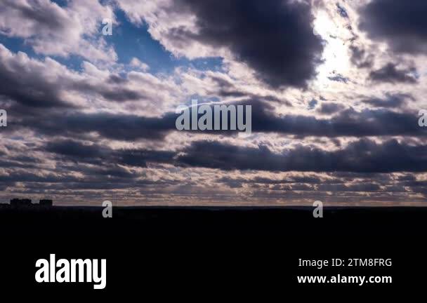 Timelapse of cumulus storm clouds moving in the sky with sun over the ...