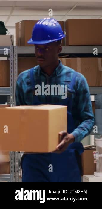 Vertical video: Diverse team of employees using tablet to scan products ...