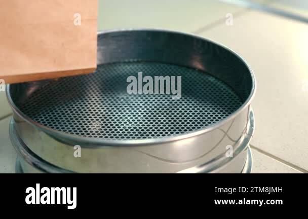 Filtration of soybeans and grains. Pouring soybeans into a filter for ...