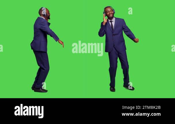 Company employee listening to music and dancing, wearing office suit ...