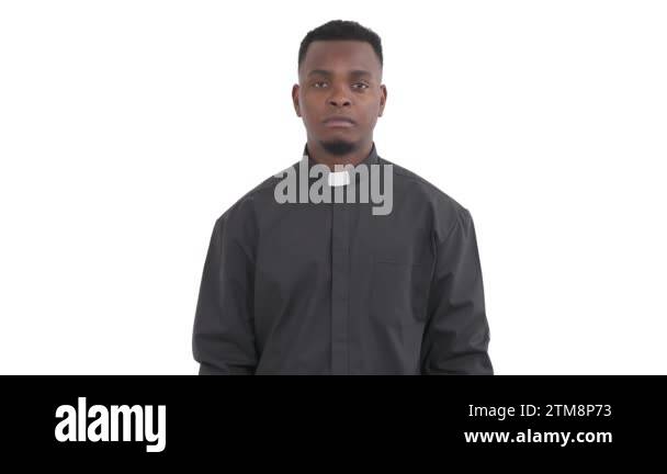 Portrait of African serious priest pointing finger up to heaven and ...